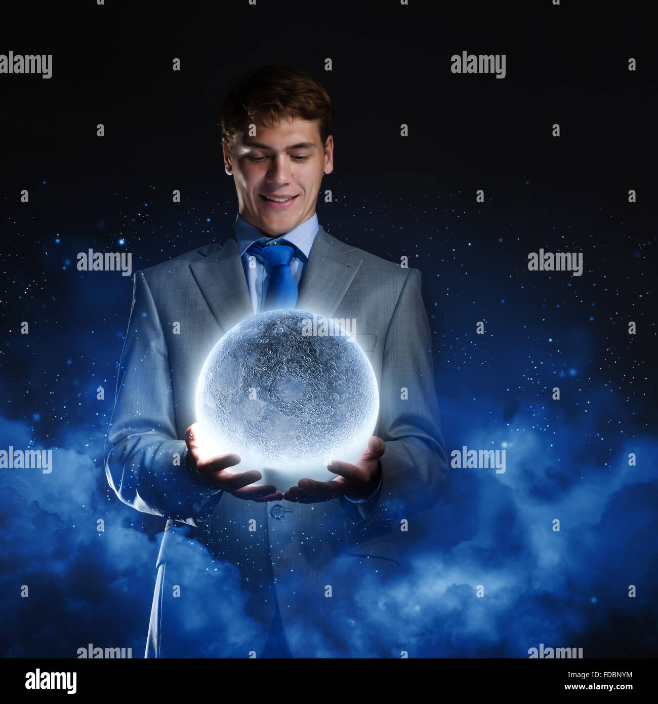 Young businessman holding moon planet in hand Stock Photo - Alamy