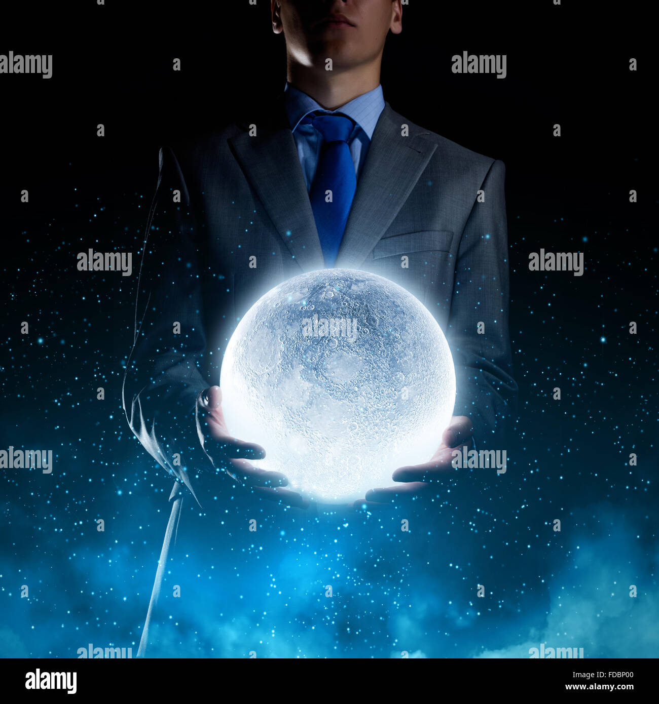 Young businessman holding moon planet in hand Stock Photo - Alamy