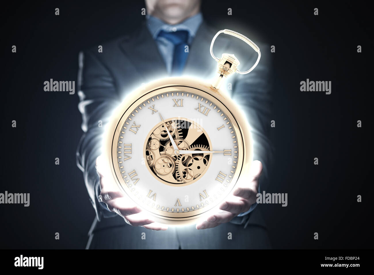 Young businessman holding pocket watch in hand Stock Photo - Alamy