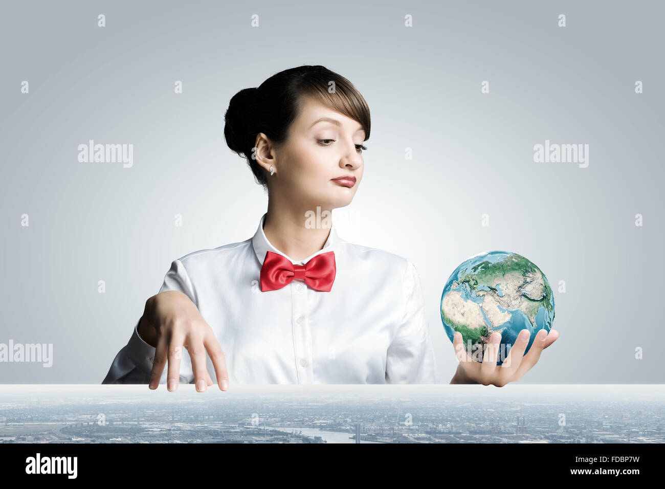 Young smiling woman holding Earth planet in hand. Elements of this ...