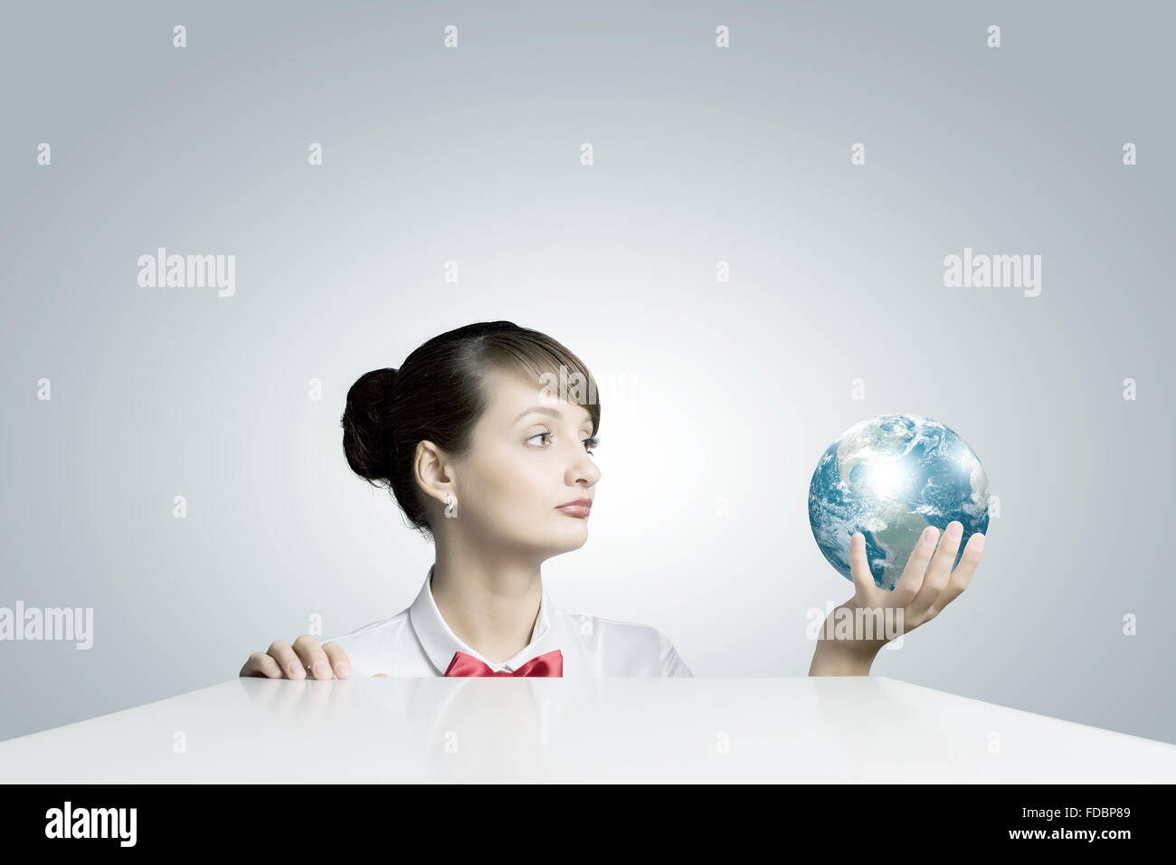 Young smiling woman holding Earth planet in hand. Elements of this ...