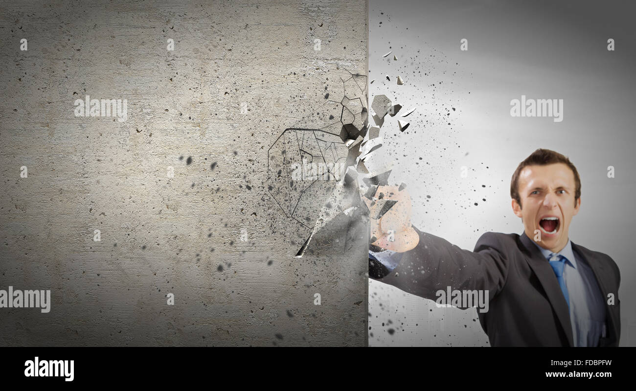 Businessman breaking stone wall with karate punch Stock Photo - Alamy