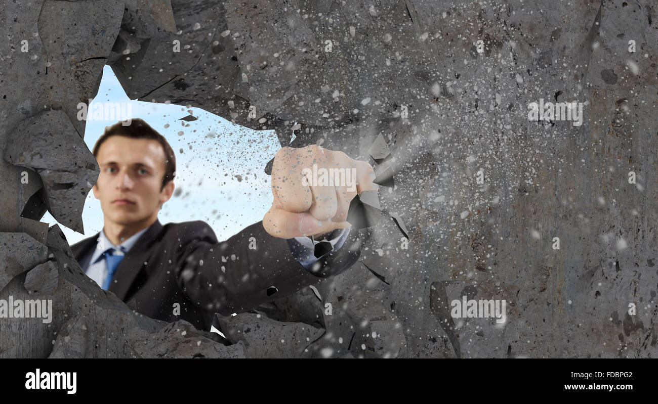 Businessman breaking stone wall with karate punch Stock Photo - Alamy