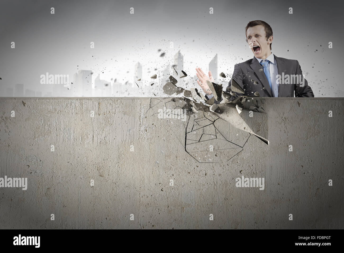 Businessman breaking stone wall with karate punch Stock Photo - Alamy