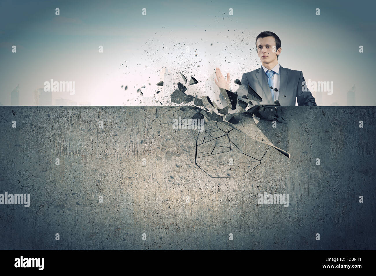 Businessman breaking stone wall with karate punch Stock Photo - Alamy