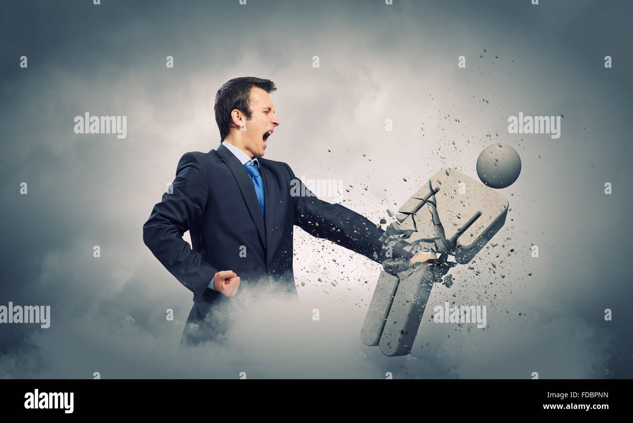 Angry young businessman fighting with stone opponent Stock Photo - Alamy