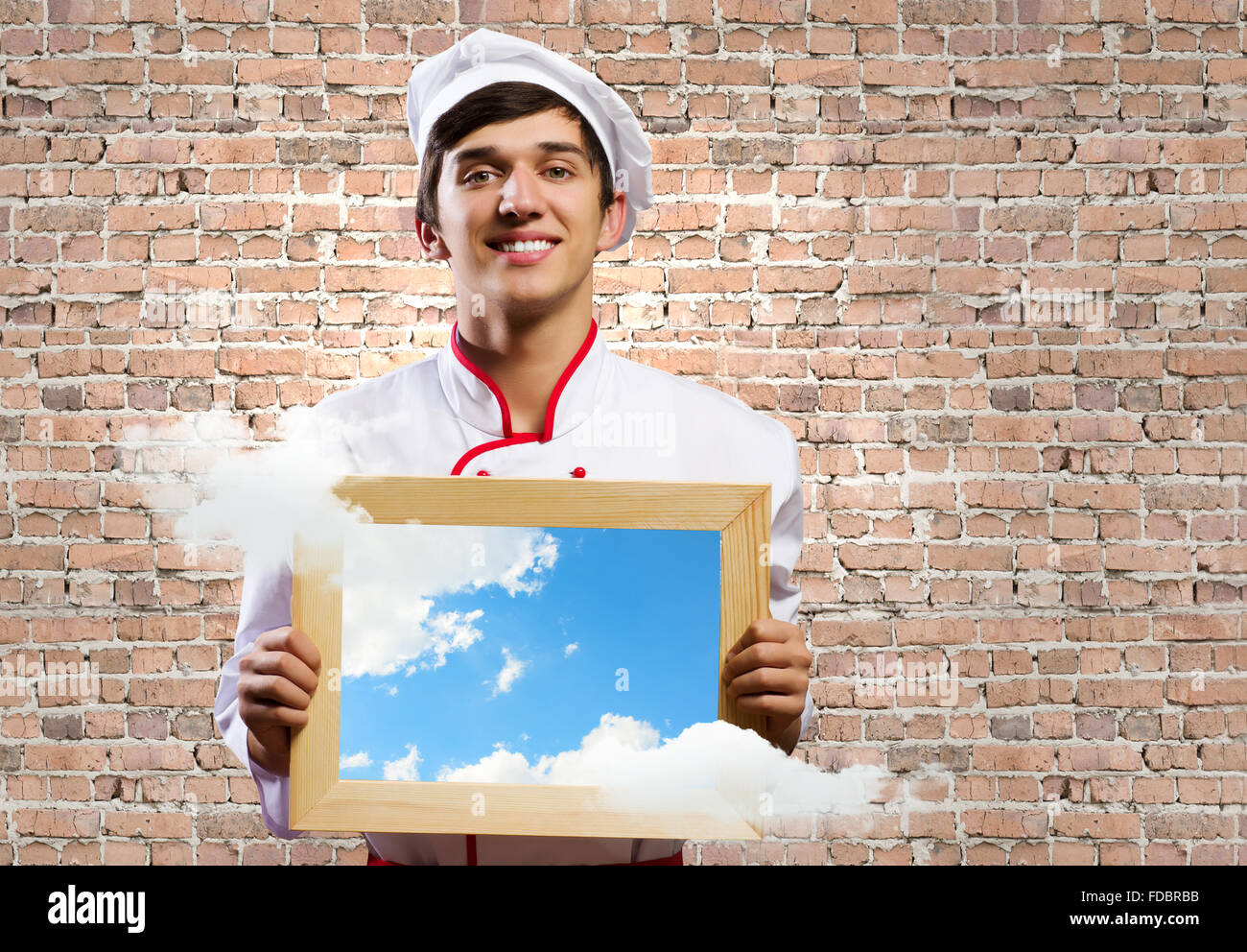 Handsome cook holding photo frame. Place for text Stock Photo - Alamy
