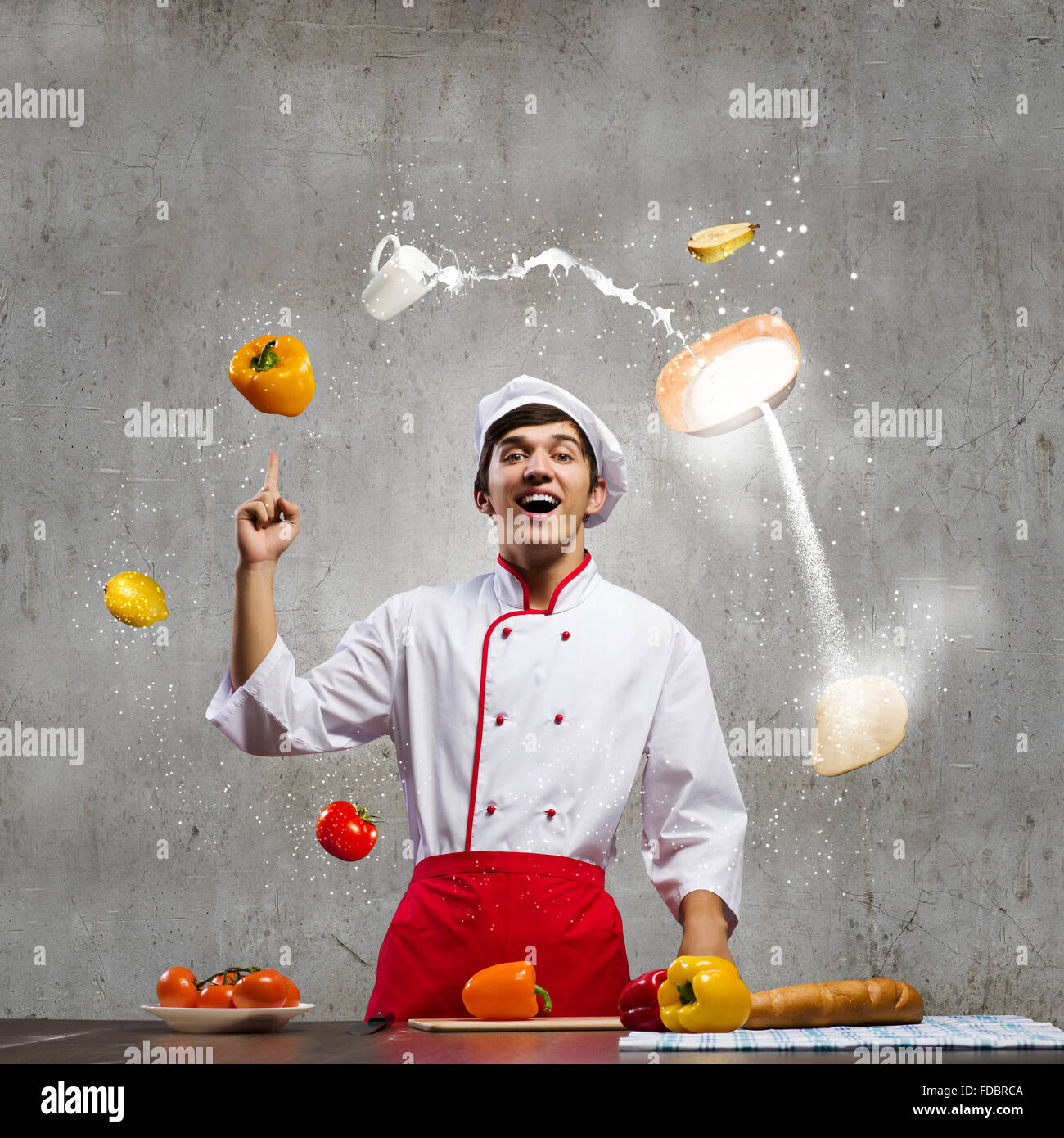 Young cheerful cook and ingredients flying in air Stock Photo - Alamy