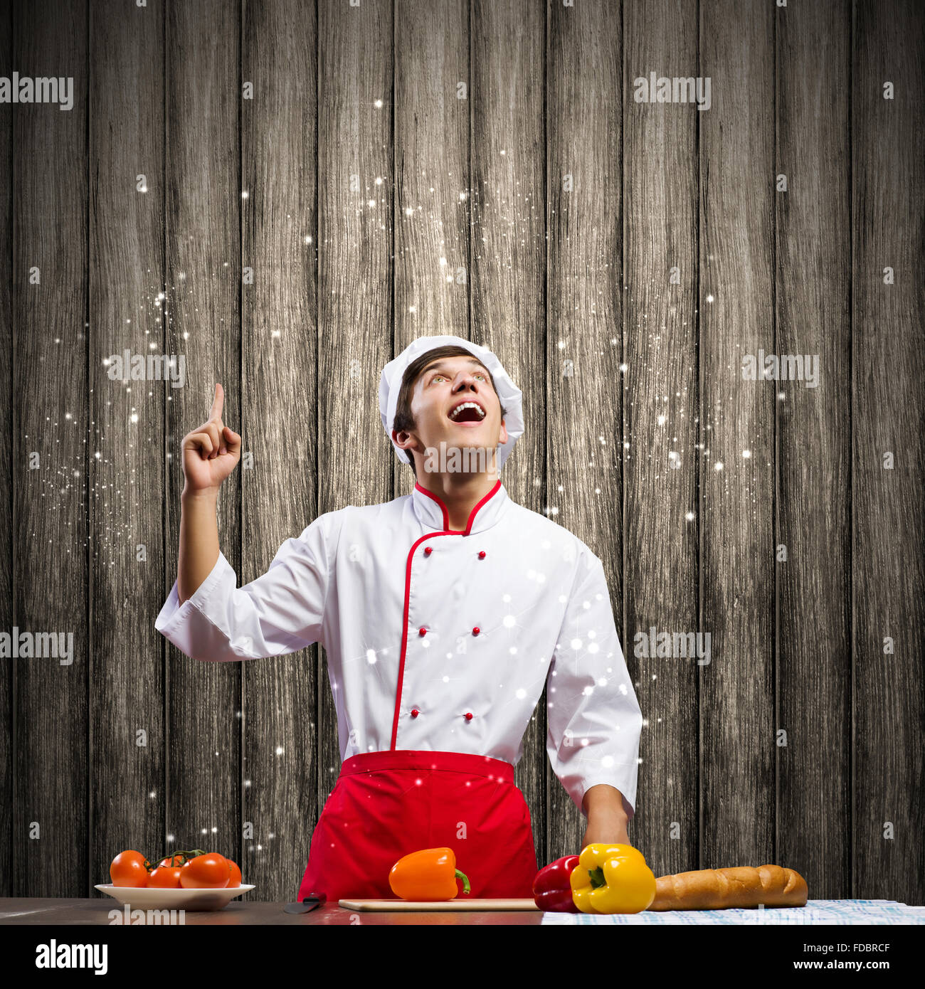 Young cheerful cook and ingredients flying in air Stock Photo - Alamy