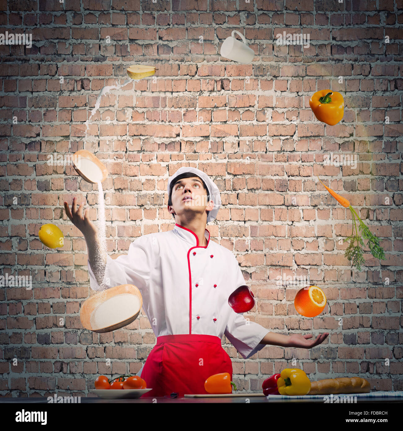Young cheerful cook and ingredients flying in air Stock Photo - Alamy