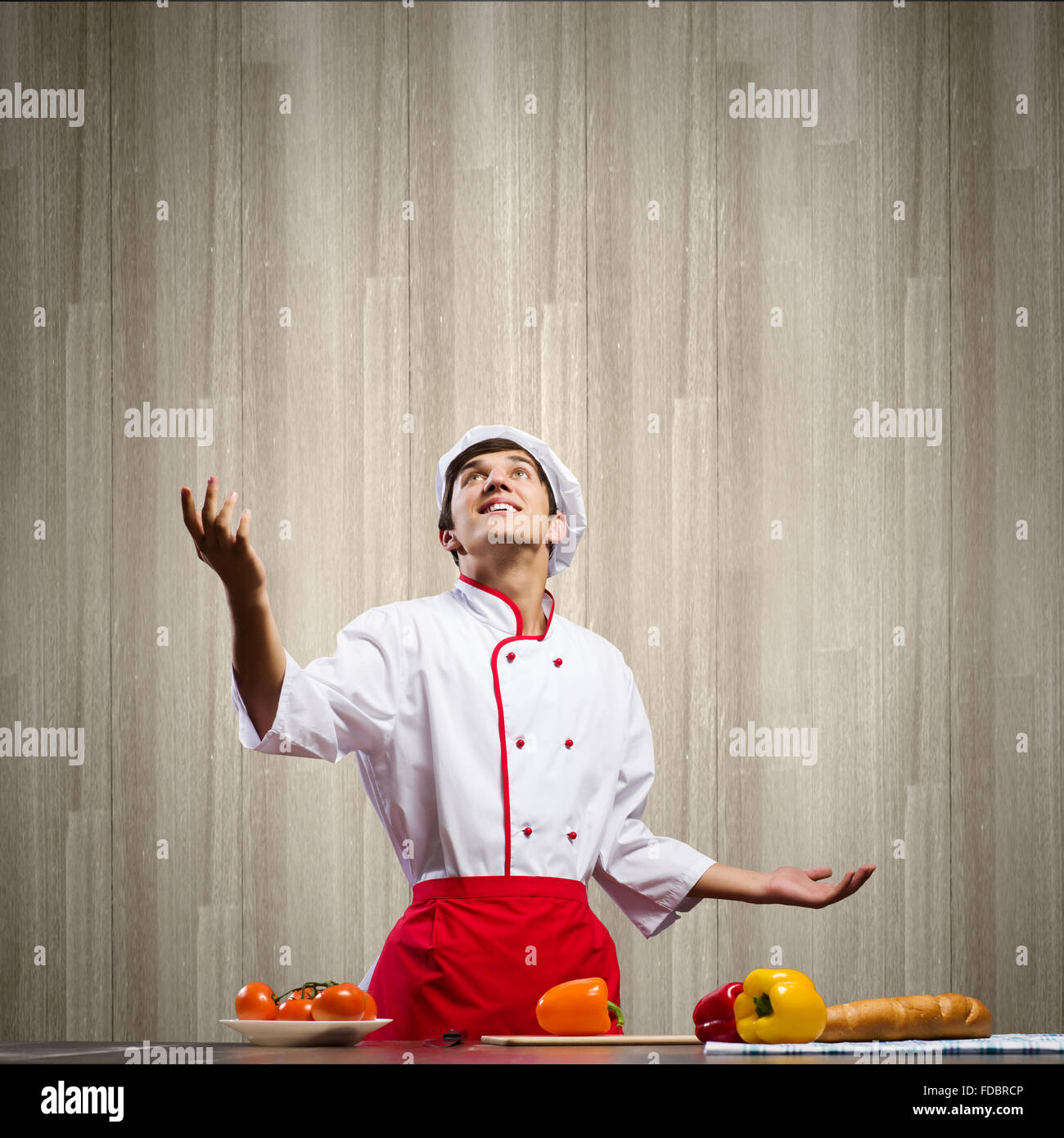 Young cheerful cook and ingredients flying in air Stock Photo - Alamy