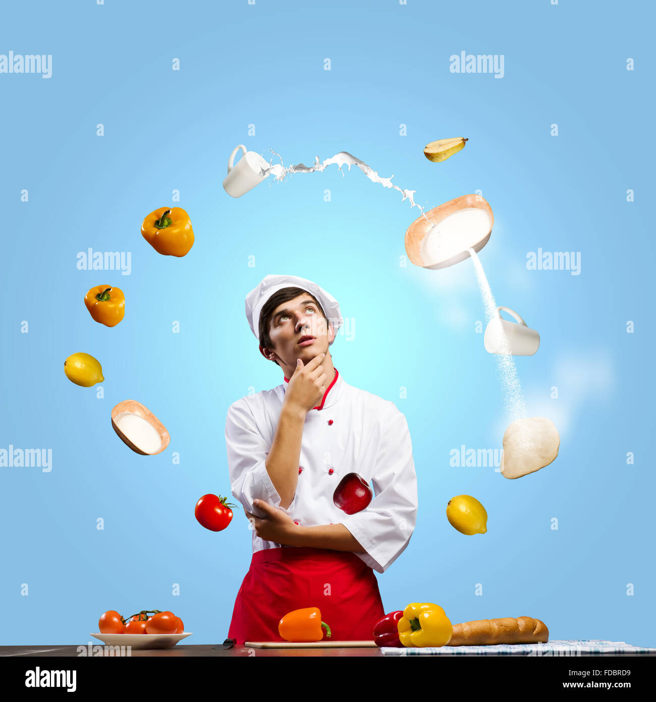 Young thoughtful cook and ingredients flying in air Stock Photo - Alamy