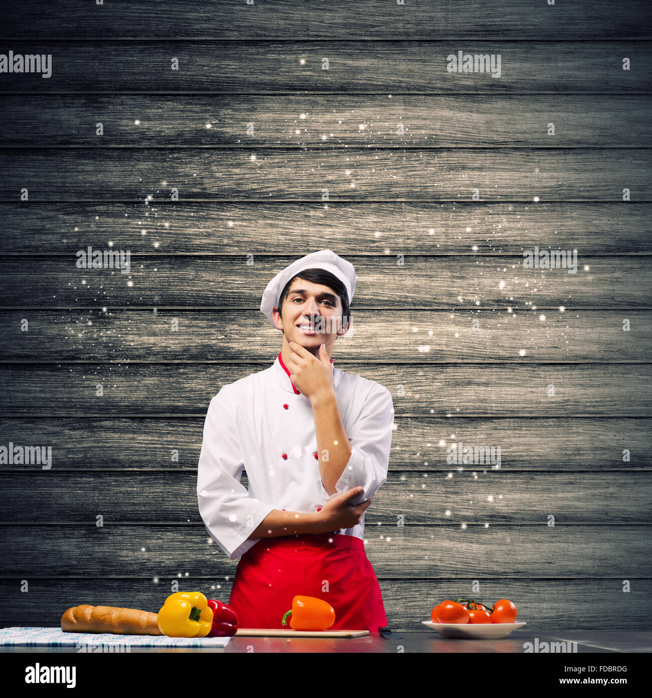 Young cheerful cook and ingredients flying in air Stock Photo - Alamy
