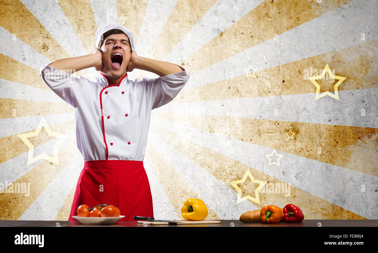 Young screaming cook and vegetables on table Stock Photo - Alamy