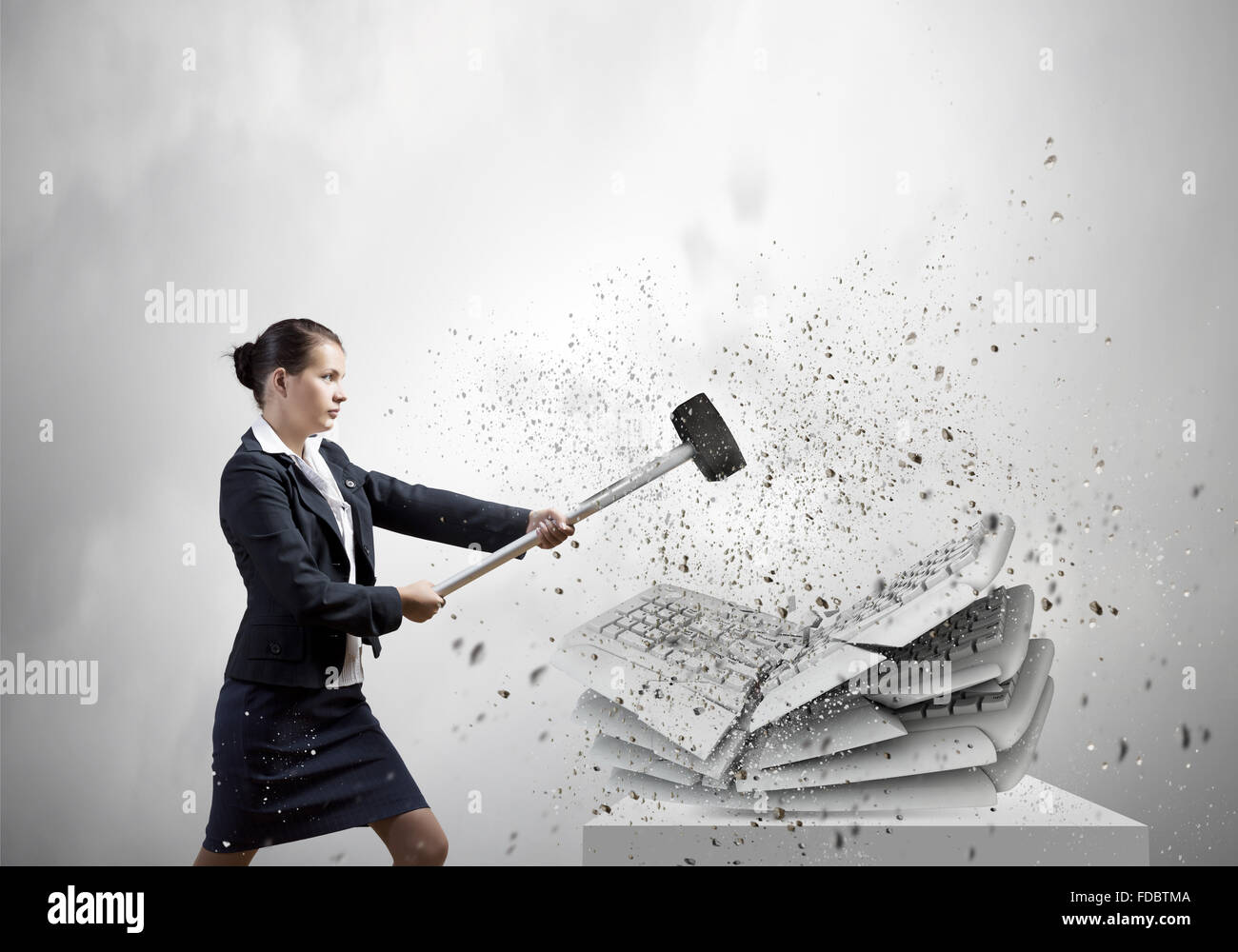 Businesswoman in anger crashing keyboard with hammer Stock Photo - Alamy