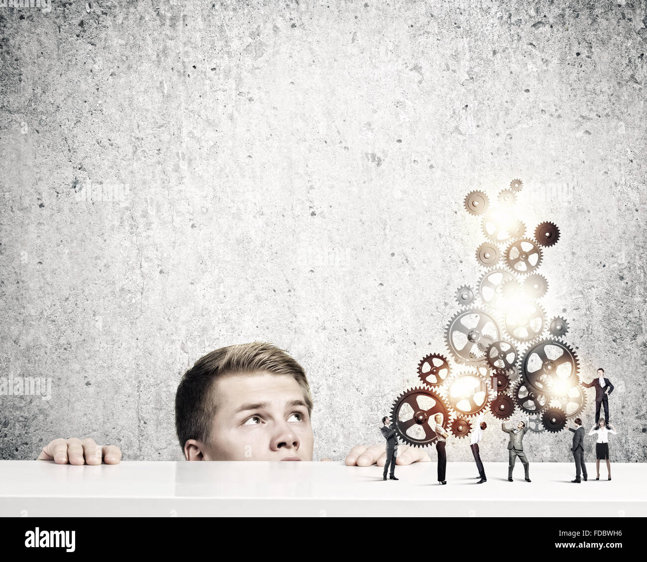 Businessman looking from under the table at businessteam Stock Photo ...