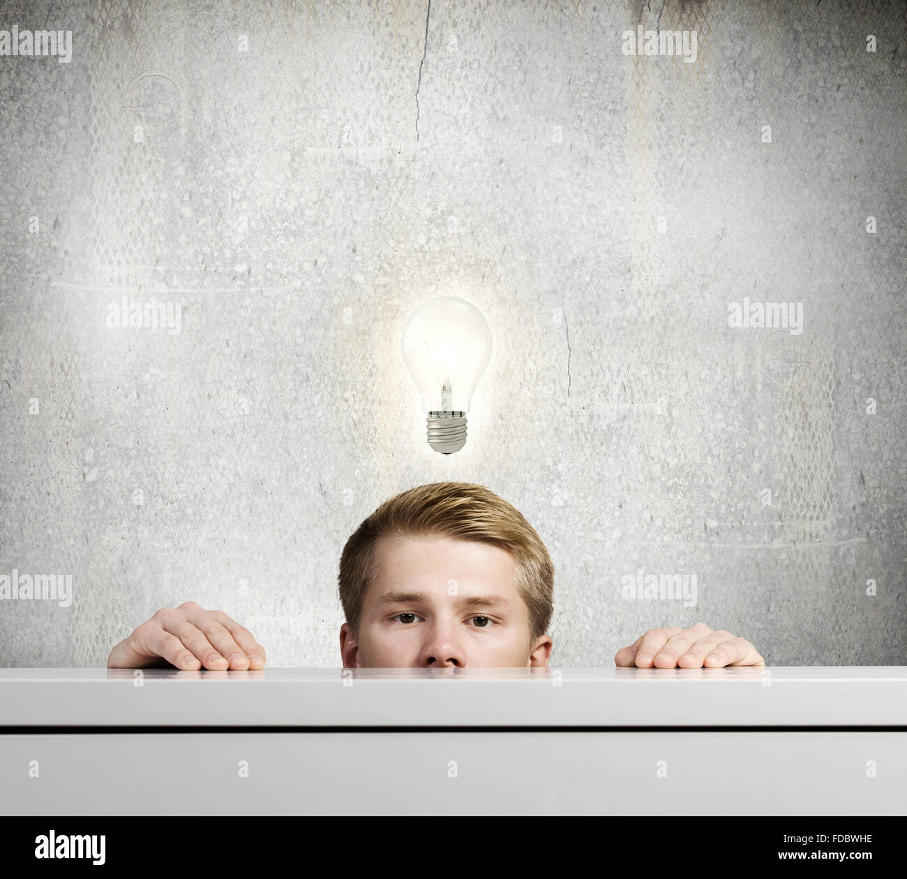 Half of face of young man looking out out from under the table Stock ...