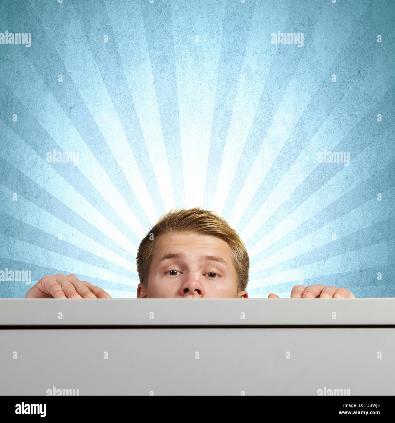 Half of face of young man looking out out from under the table Stock ...