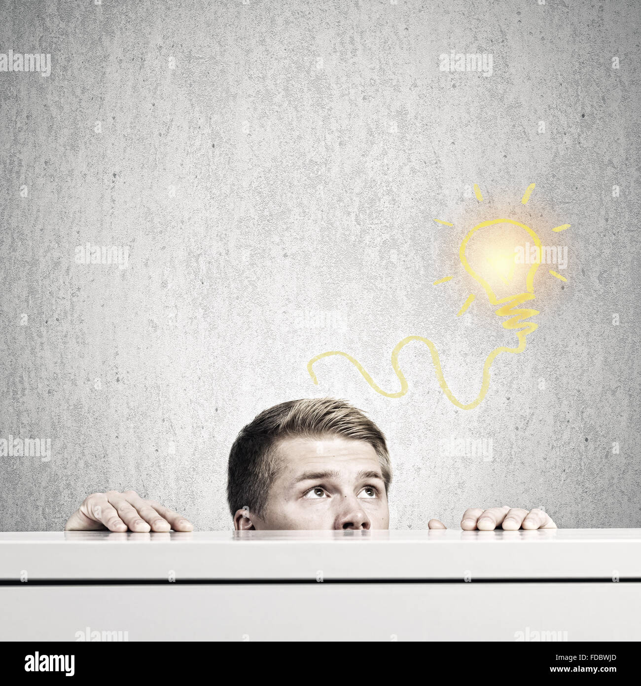 Half of face of young man looking out out from under the table Stock ...