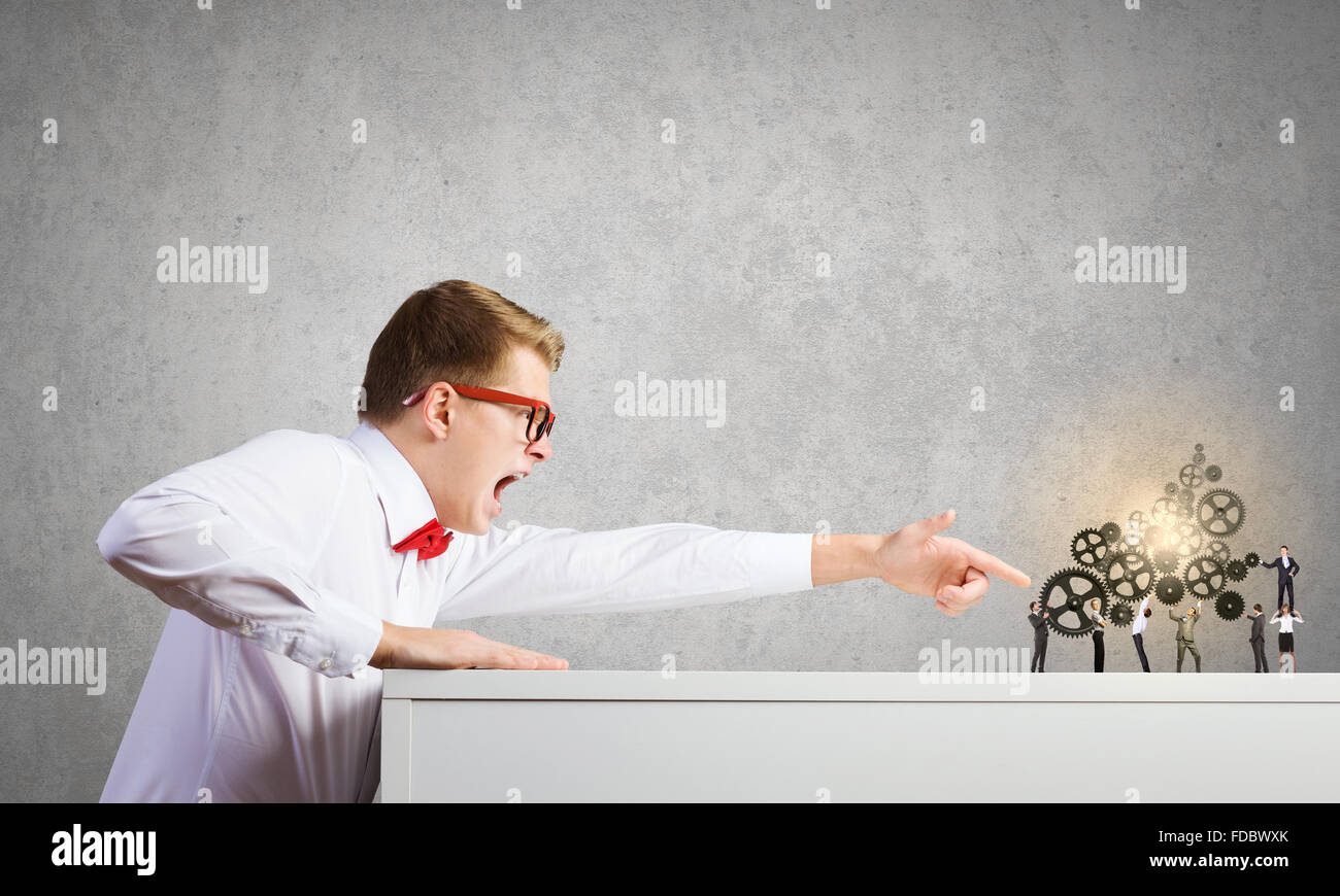 Businessman looking from under the table at businessteam Stock Photo ...