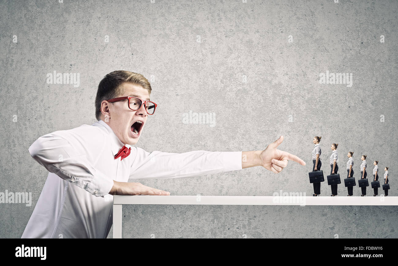 Angry businessman screaming at miniature of woman colleague Stock Photo ...