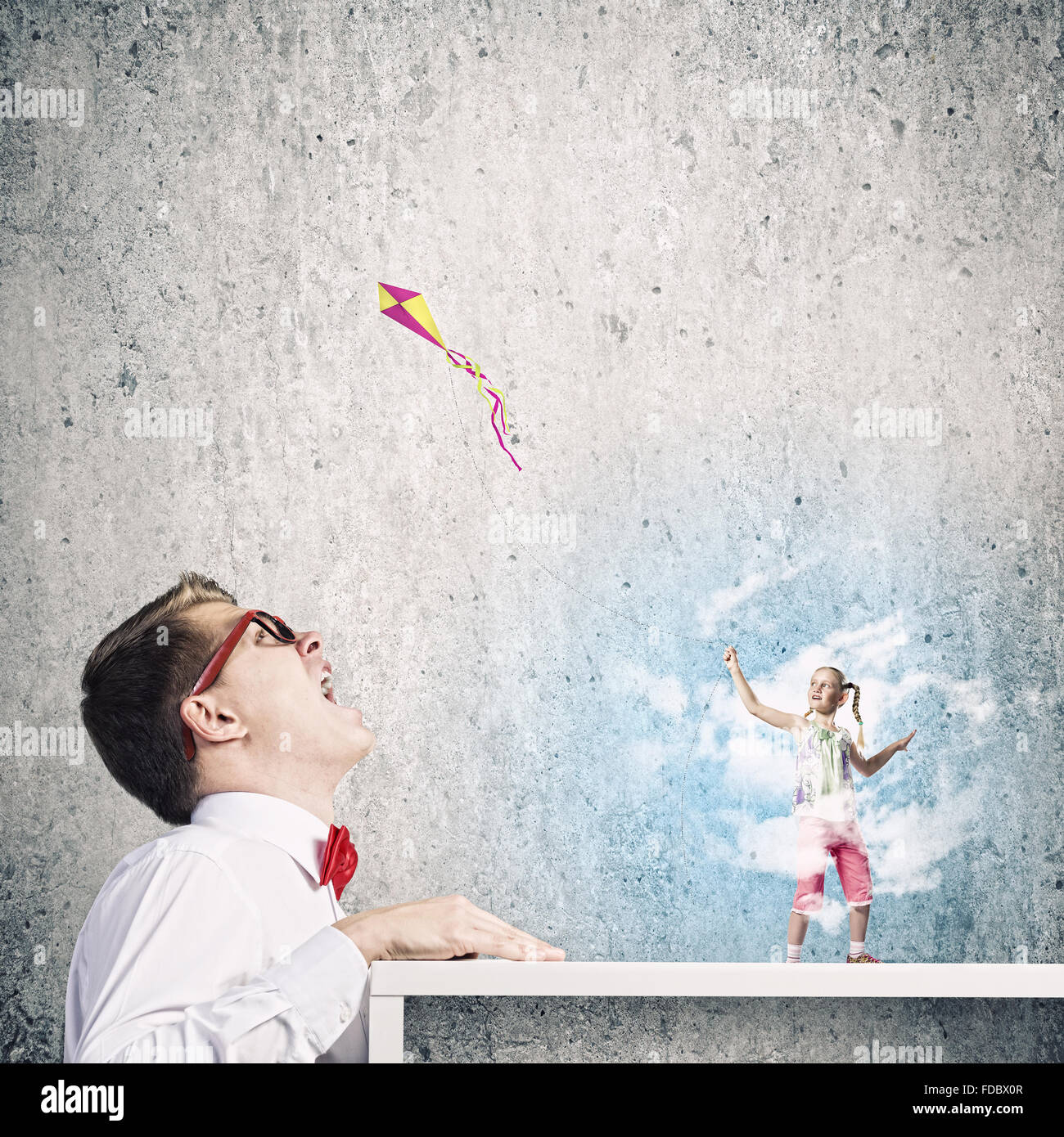 Young man looking out from under the table Stock Photo - Alamy