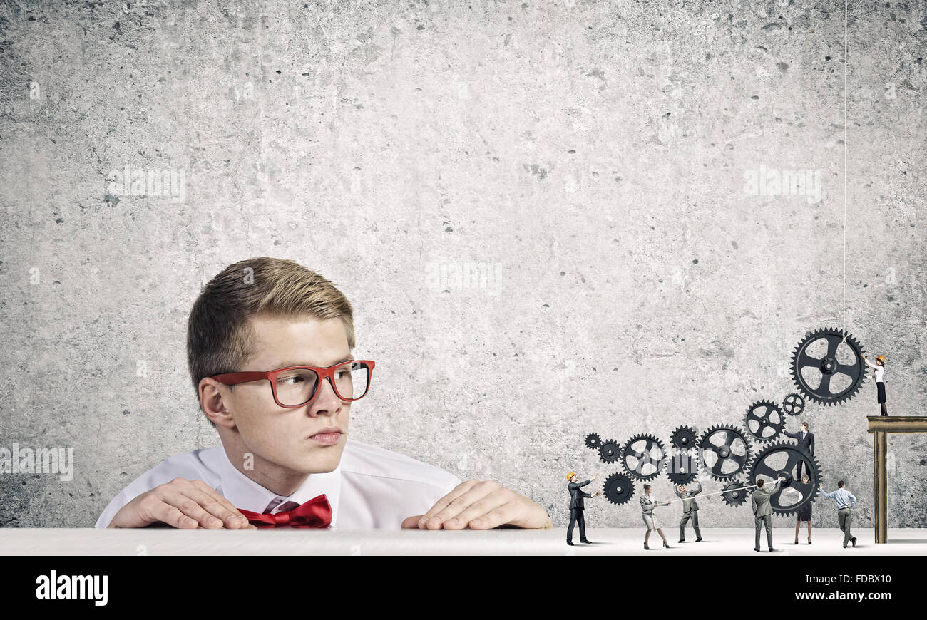 Businessman looking from under the table at businessteam Stock Photo ...