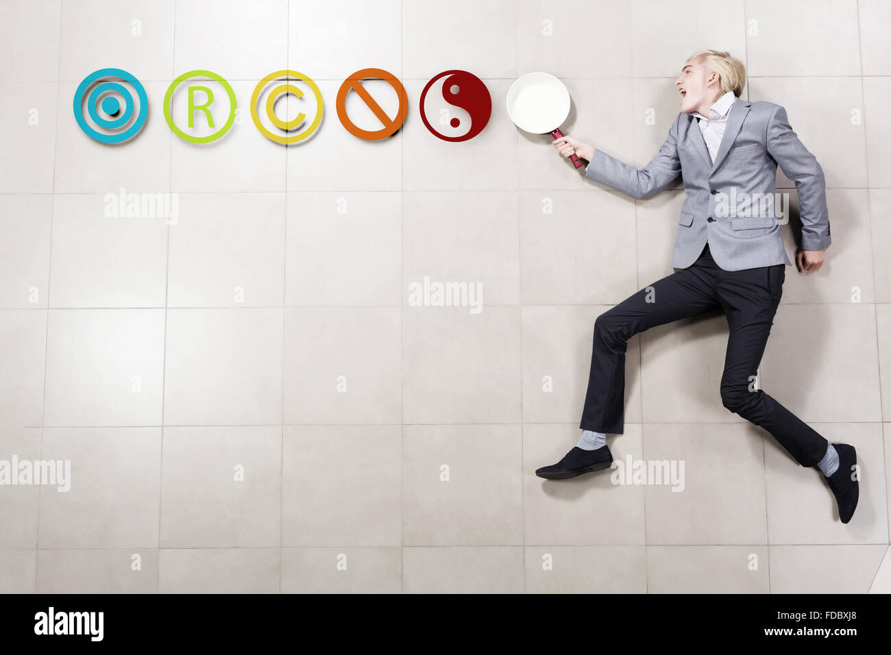 Funny image of young running businessman with pan in hand Stock Photo ...