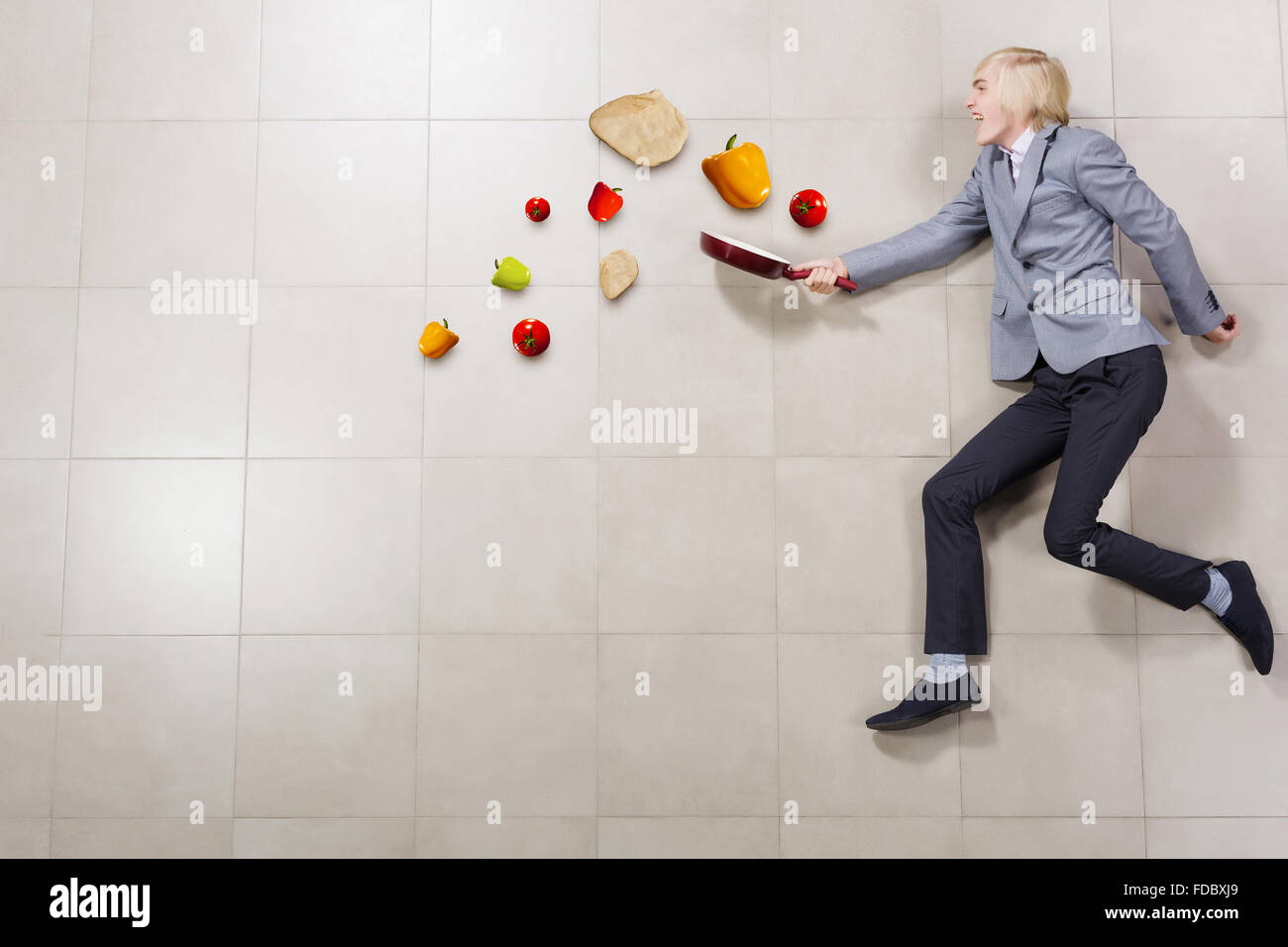 Funny image of young running businessman with pan in hand Stock Photo ...