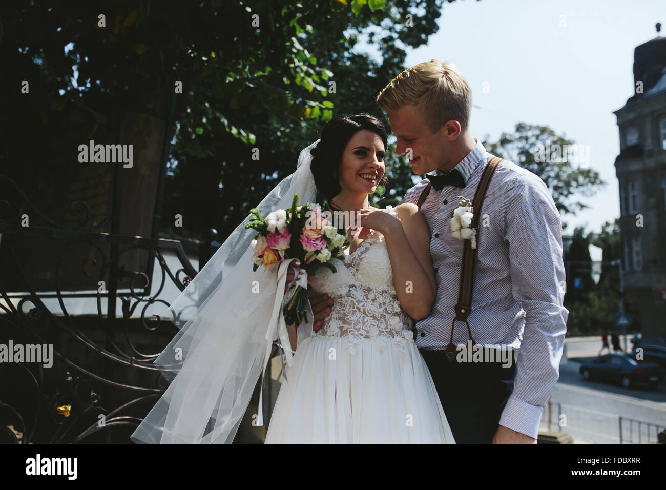 bride and groom posing on the streets of the old town Stock Photo - Alamy