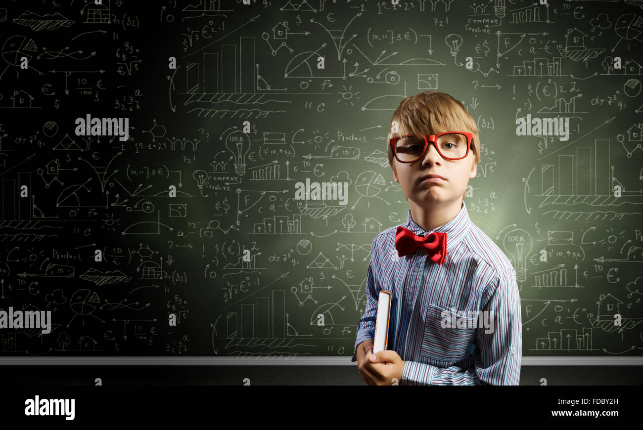 Genius boy in red glasses near blackboard with formulas Stock Photo - Alamy
