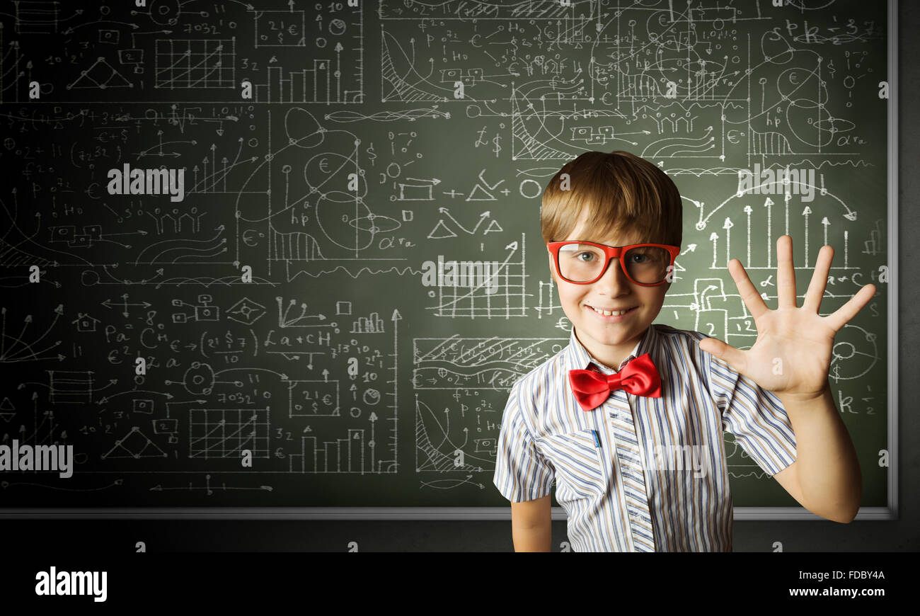 Genius boy in red glasses near blackboard with formulas Stock Photo - Alamy