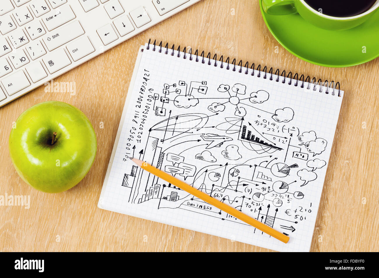 Keyboard cup of coffee and notepad at table Stock Photo - Alamy