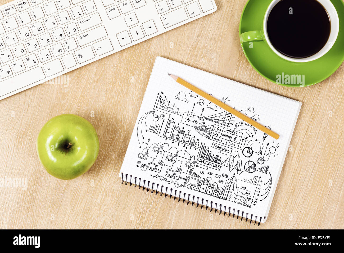 Keyboard cup of coffee and notepad at table Stock Photo - Alamy