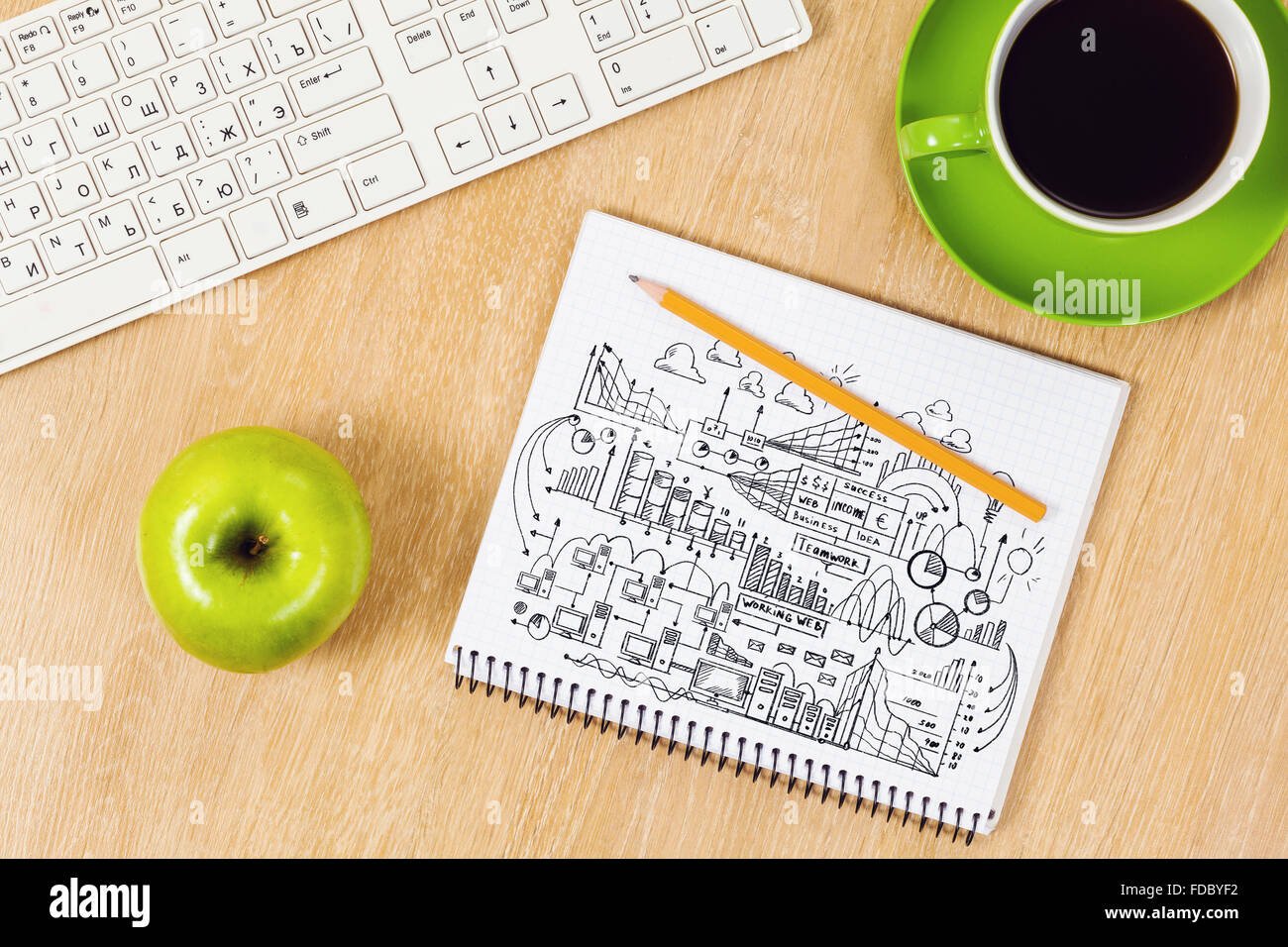 Keyboard cup of coffee and notepad at table Stock Photo - Alamy