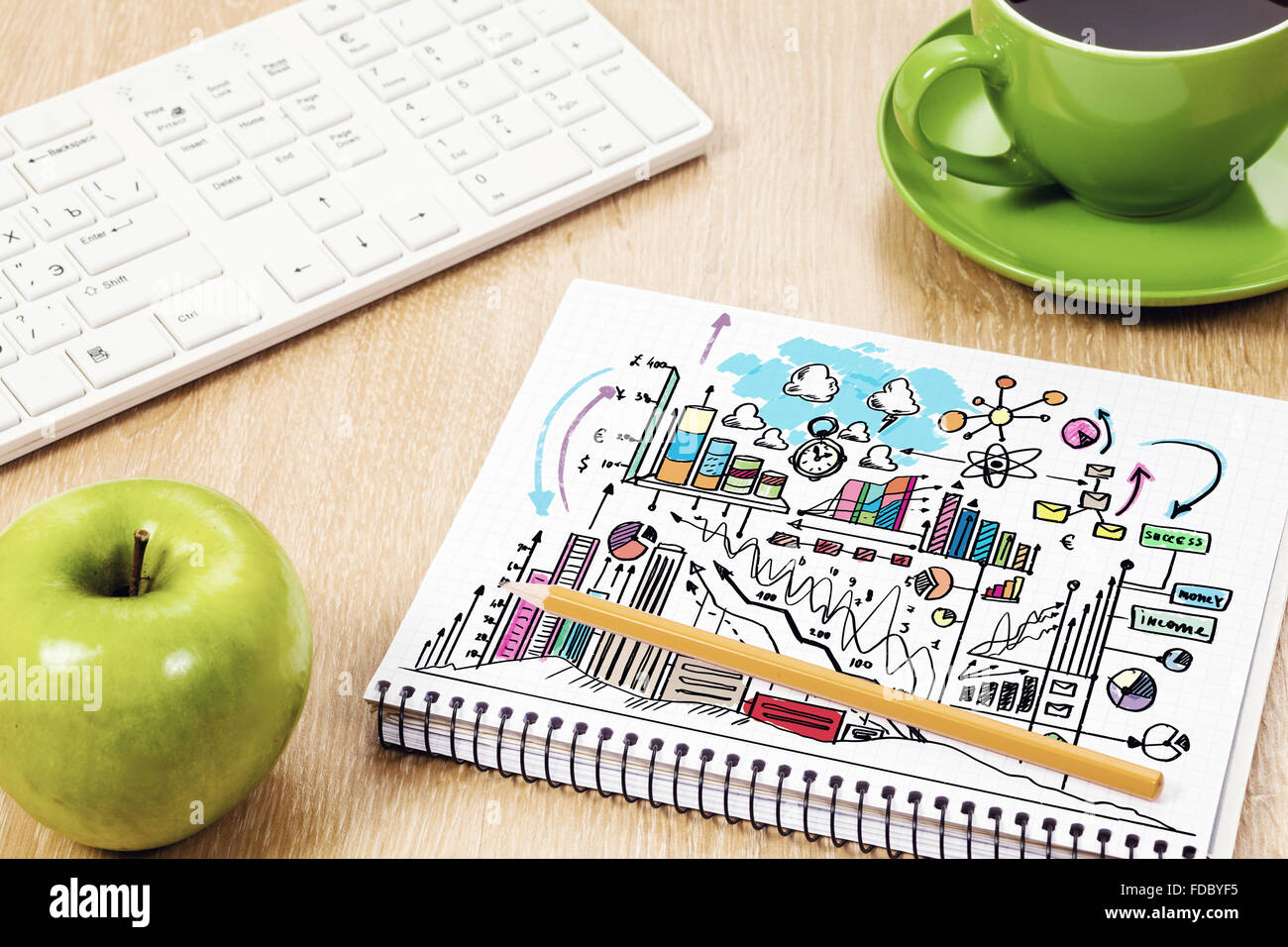 Keyboard cup of coffee and notepad at table Stock Photo - Alamy