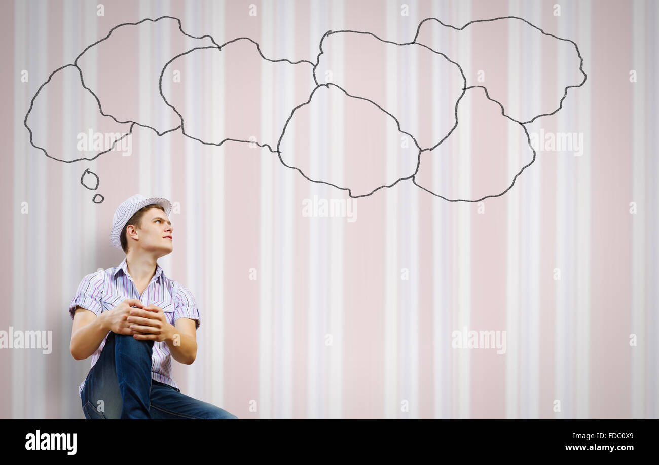 Young man in casual sitting and thinking. Creativity concept Stock ...