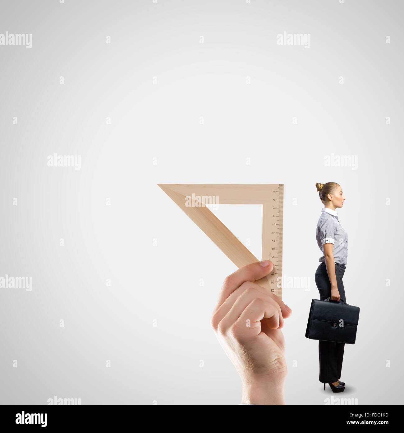 Businessman measuring miniature of business lady with ruler Stock Photo ...