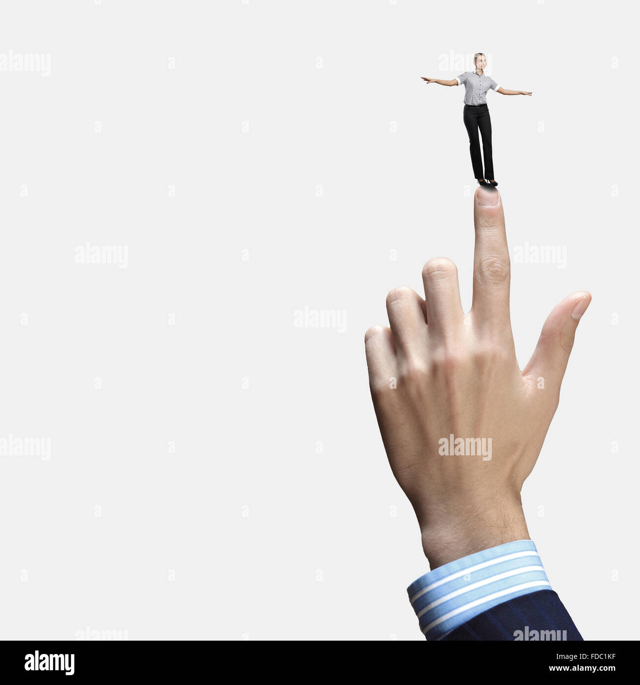 Young businesswoman balancing on finger of businessman Stock Photo - Alamy