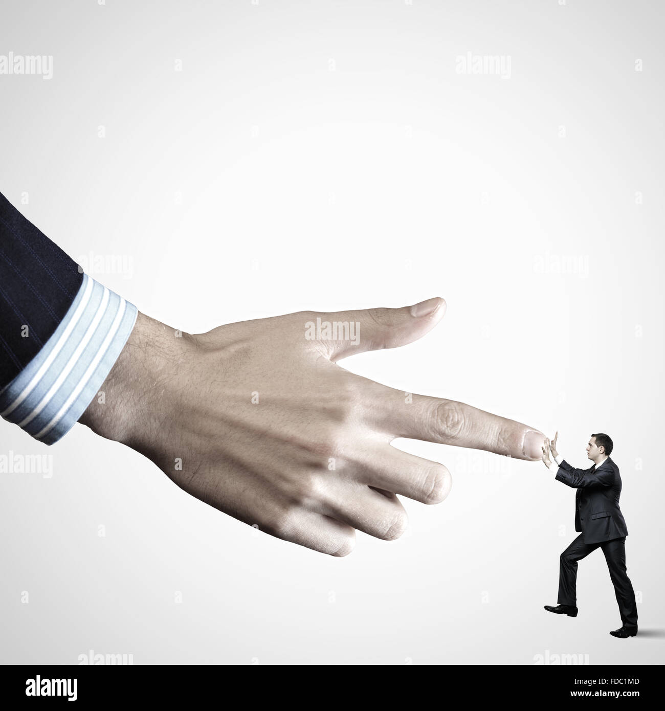 Close up of male businessman pointing at miniature of man Stock Photo ...