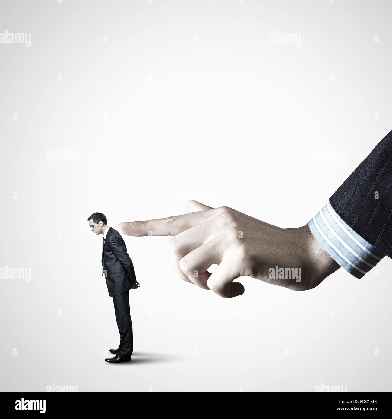 Close up of male businessman pointing at miniature of man Stock Photo ...