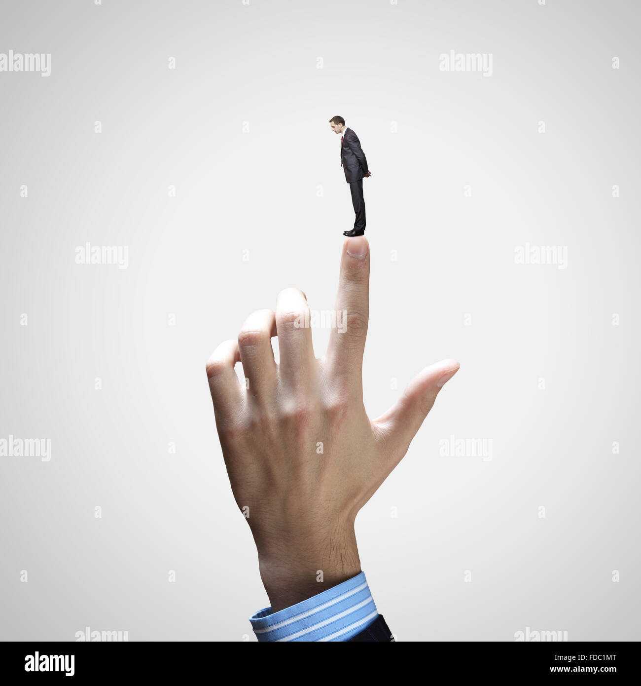 Close up of male businessman pointing at miniature of man Stock Photo ...