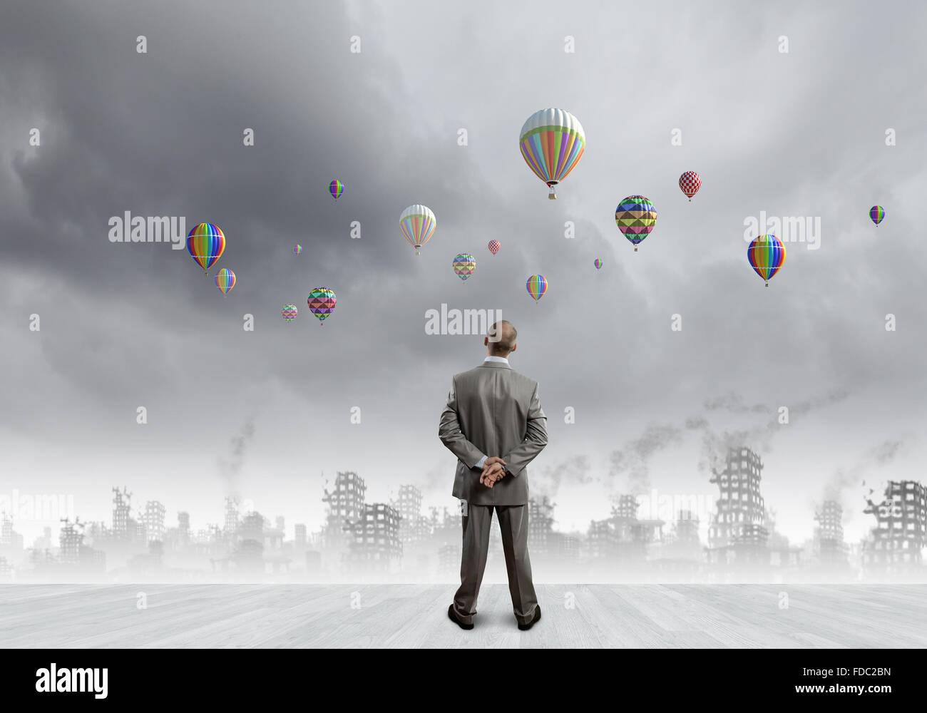 Rear view of businessman looking at aerostats flying above city Stock ...