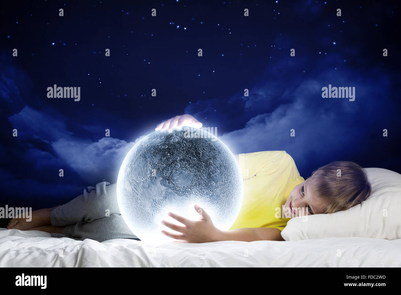 Cute boy sleeping in bed with moon Stock Photo - Alamy