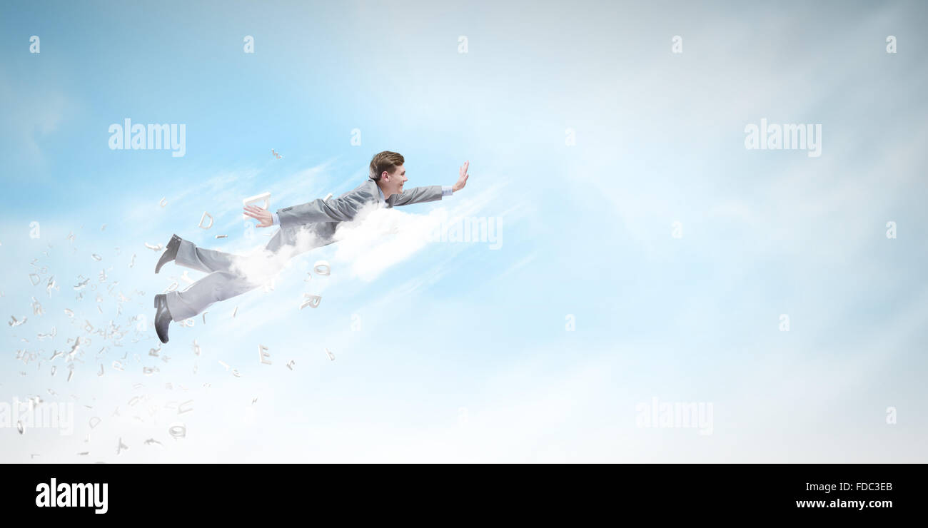 Young super businessman flying high in sky Stock Photo - Alamy