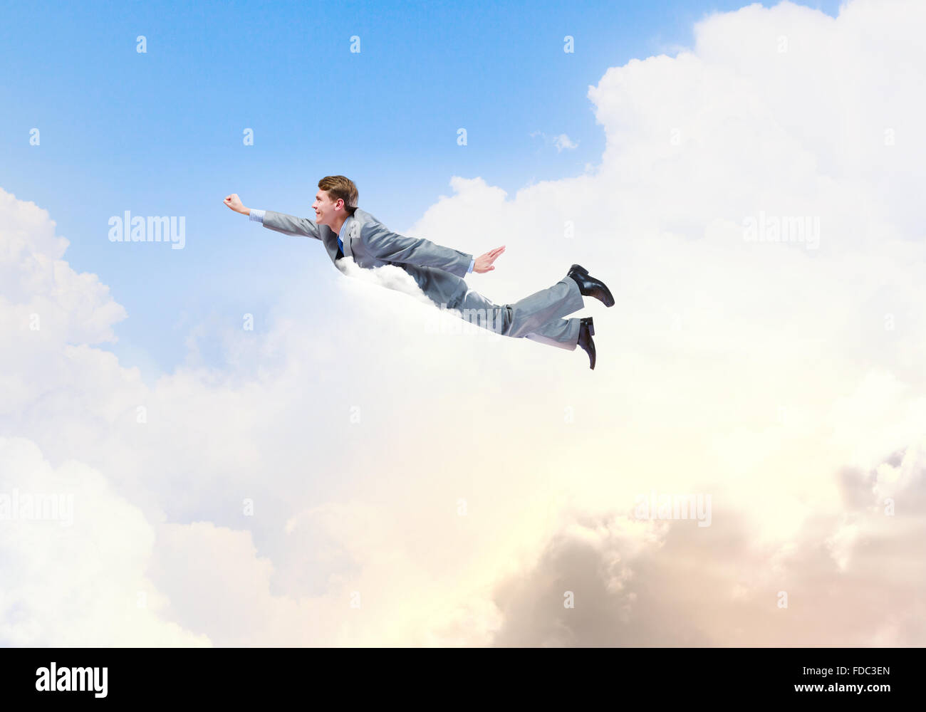 Young super businessman flying high in sky Stock Photo - Alamy