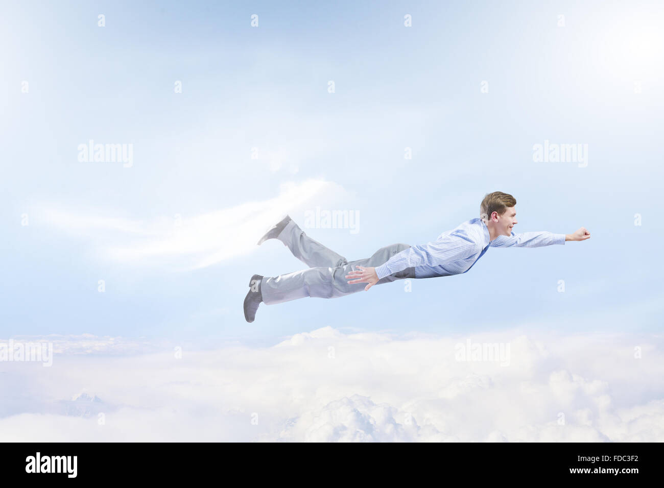 Young super businessman flying high in sky Stock Photo - Alamy