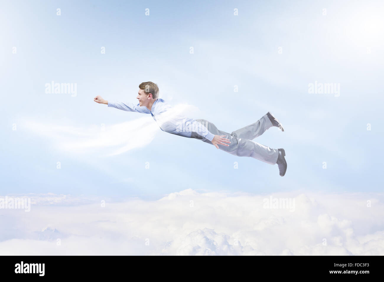 Young super businessman flying high in sky Stock Photo - Alamy