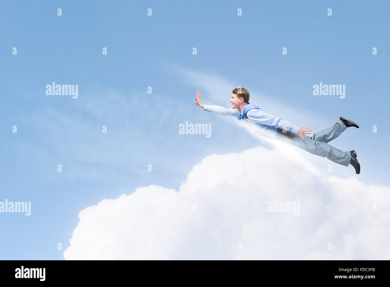 Young super businessman flying high in sky Stock Photo - Alamy