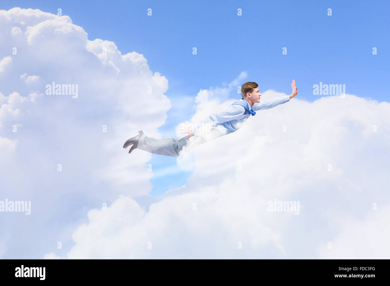 Young super businessman flying high in sky Stock Photo - Alamy